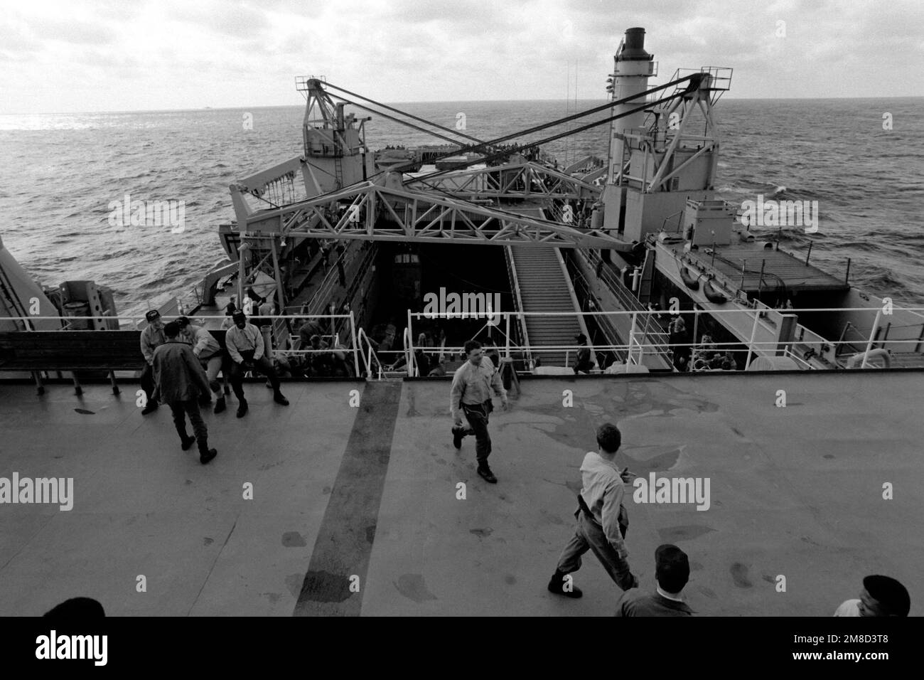 Sailors aboard the dock landing ship USS FORT FISHER (LSD-40) move to ...