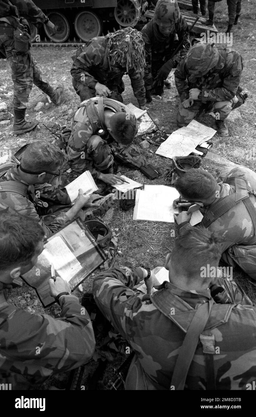 Members of the Army's 7th Infantry Division (Light) check their maps as ...