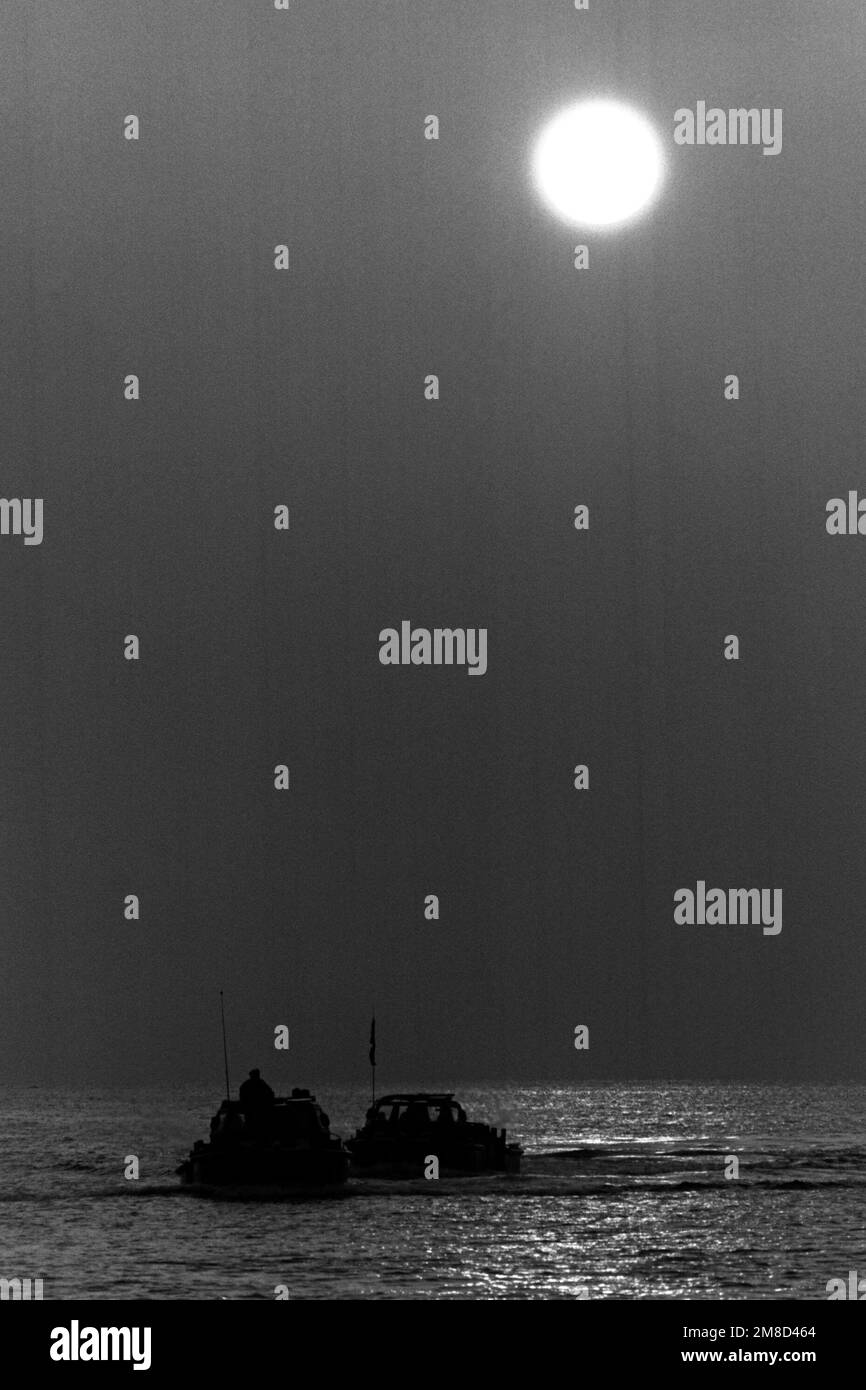 Two LARC-5 amphibious resupply cargo lighters head ashore during the ...