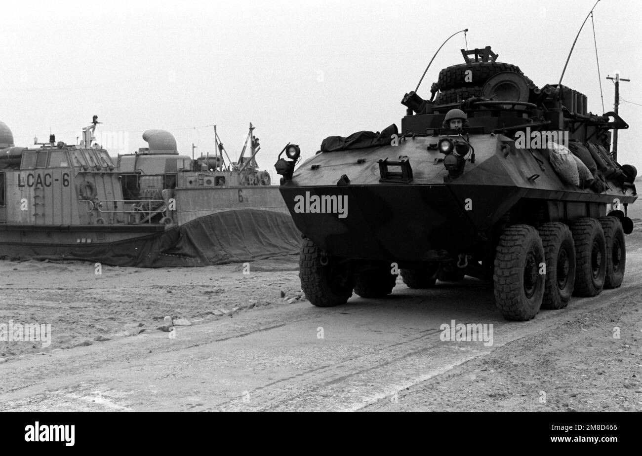 A Marine Corps LAV-L light armored logistics vehicle moves past the air ...