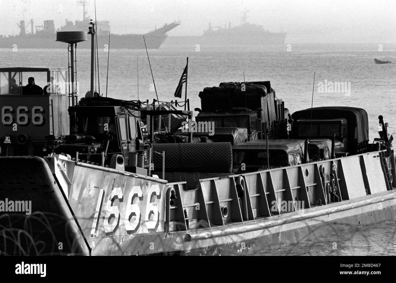 The utility landing craft LCU-1666 arrives at the shore line with a ...