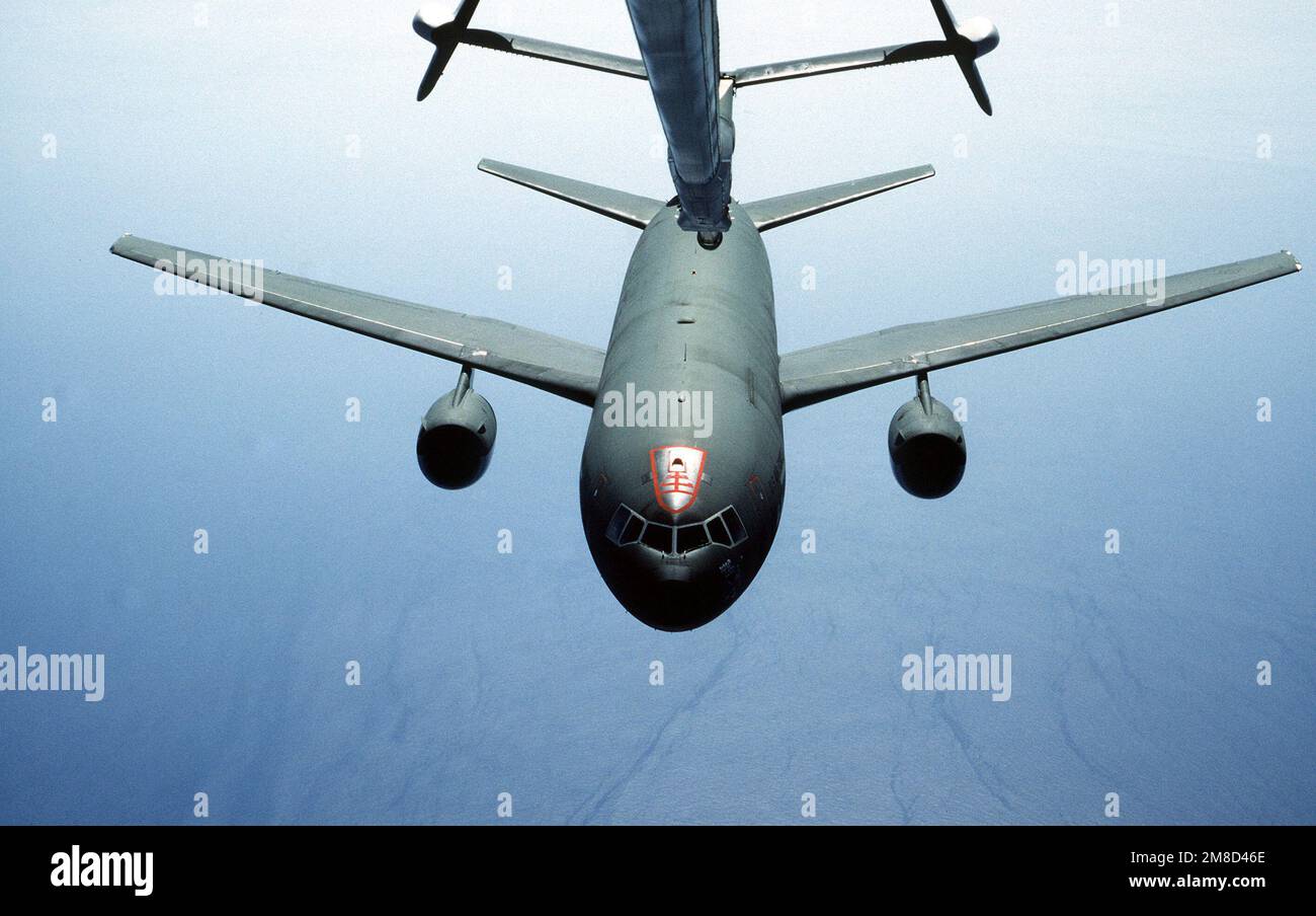 A KC-10A Extender aircraft approaches the refueling boom of an Extender ...