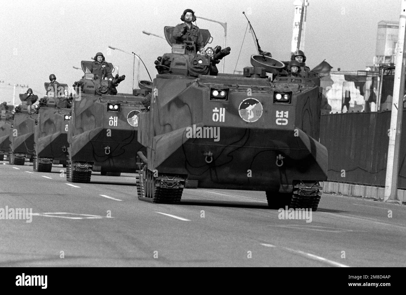 A convoy of South Korean marine corps LVTP-7 tracked landing vehicles moves along a road during ...