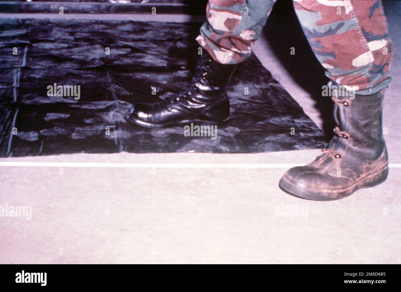 A soldier demonstrates a multi-purpose overboot (MULO),. Country ...