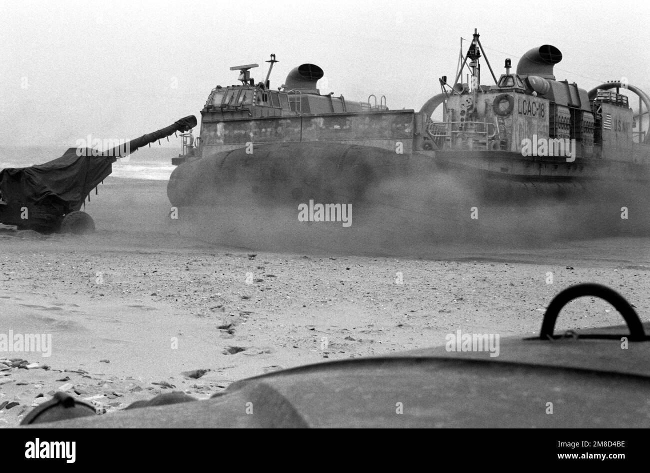 The air cushion landing craft LCAC-18 backs away from the beach after ...
