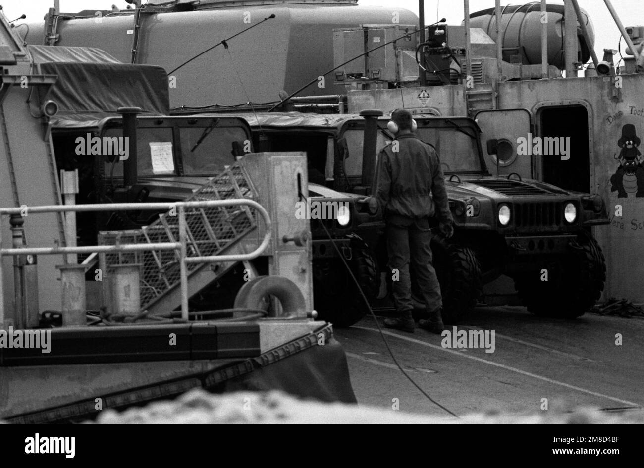 Two M998 High-Mobility Multipurpose Wheeled Vehicles (HMMWV) are driven ...