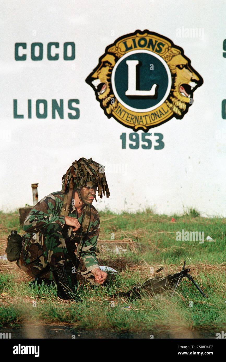 A soldier from Headquarters Company, Task Force 2-27, kneels in front ...
