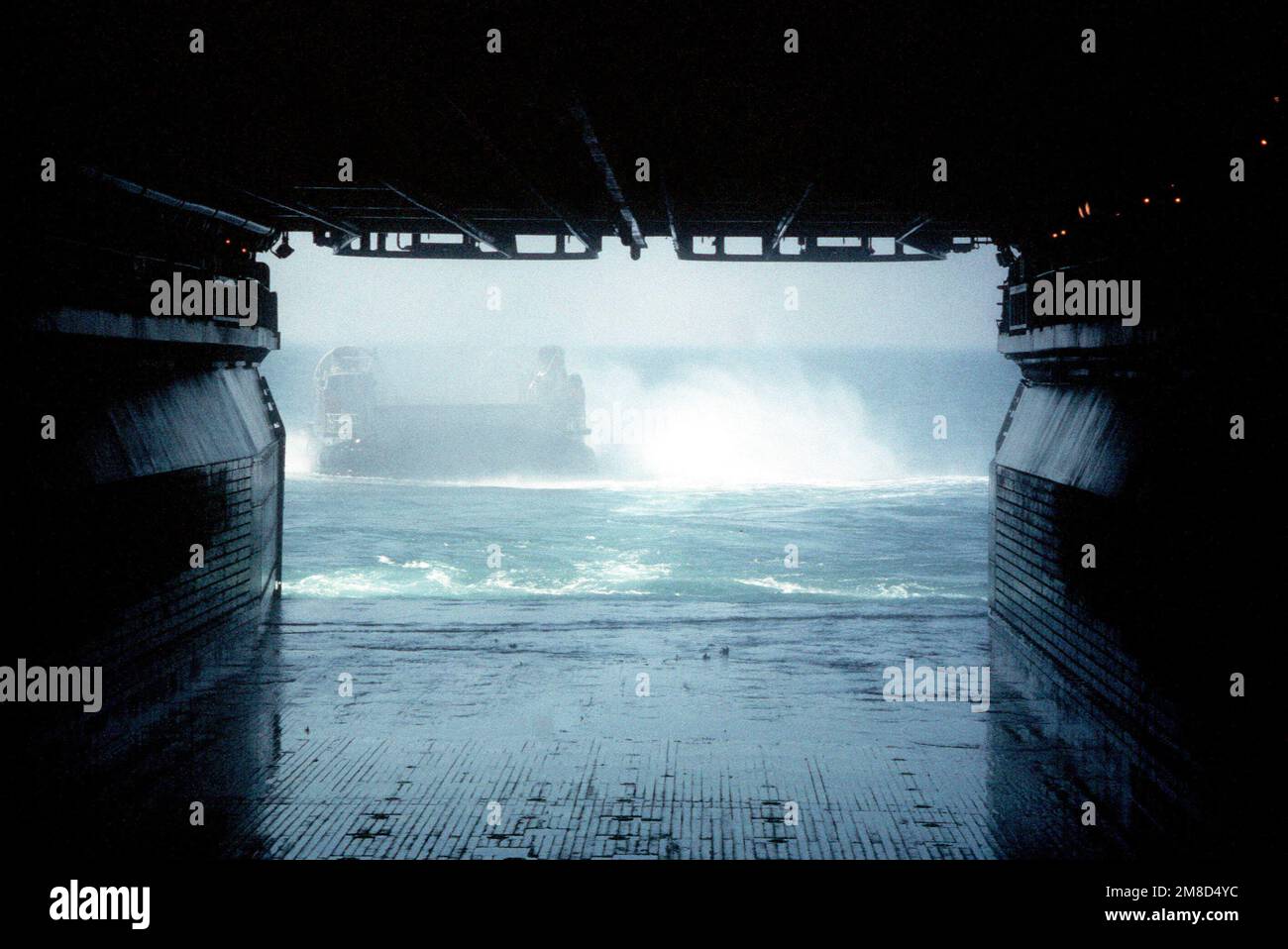The air-cushion landing craft LCAC-15 approaches the well deck of the ...