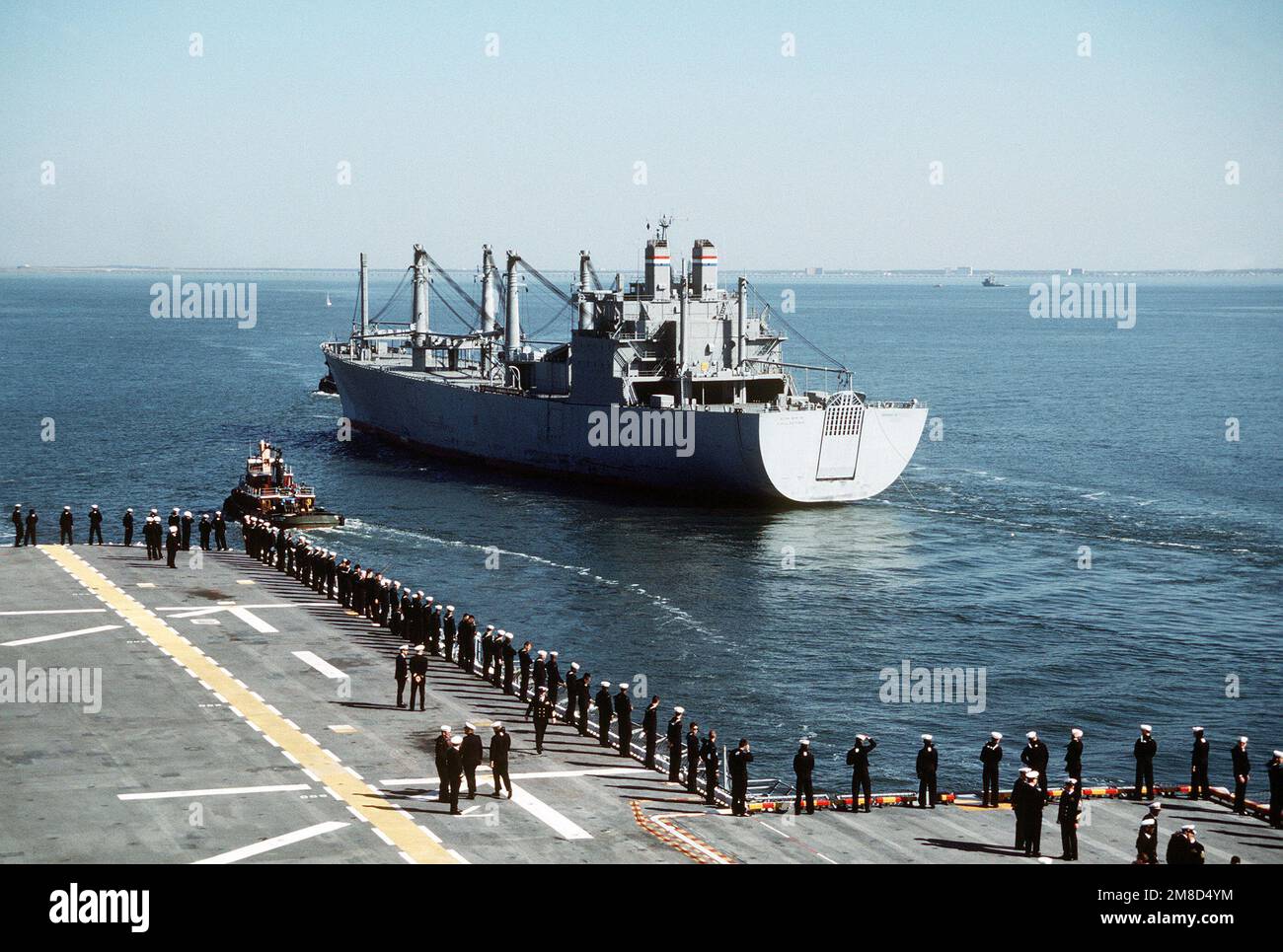 The amphibious assault ship USS WASP (LHD-1) passes the vehicle cargo ...