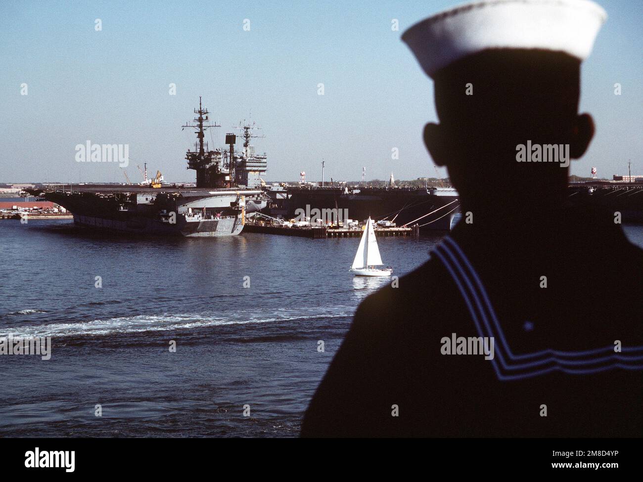 A sailor mans the rails aboard the amphibious assault ship USS WASP ...