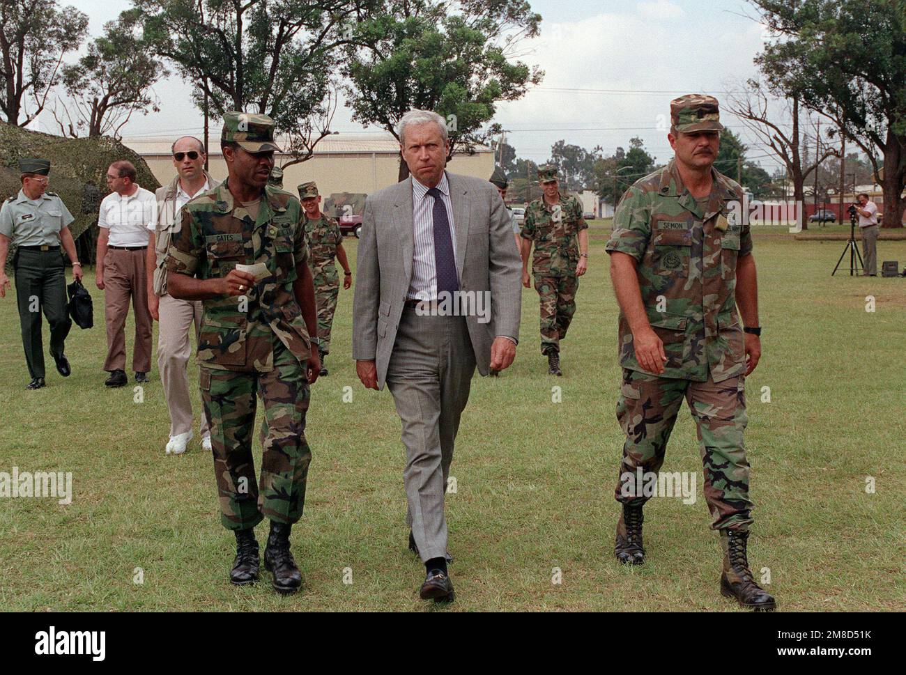 Secretary of the Army Michael Stone, center, is escorted by two senior ...