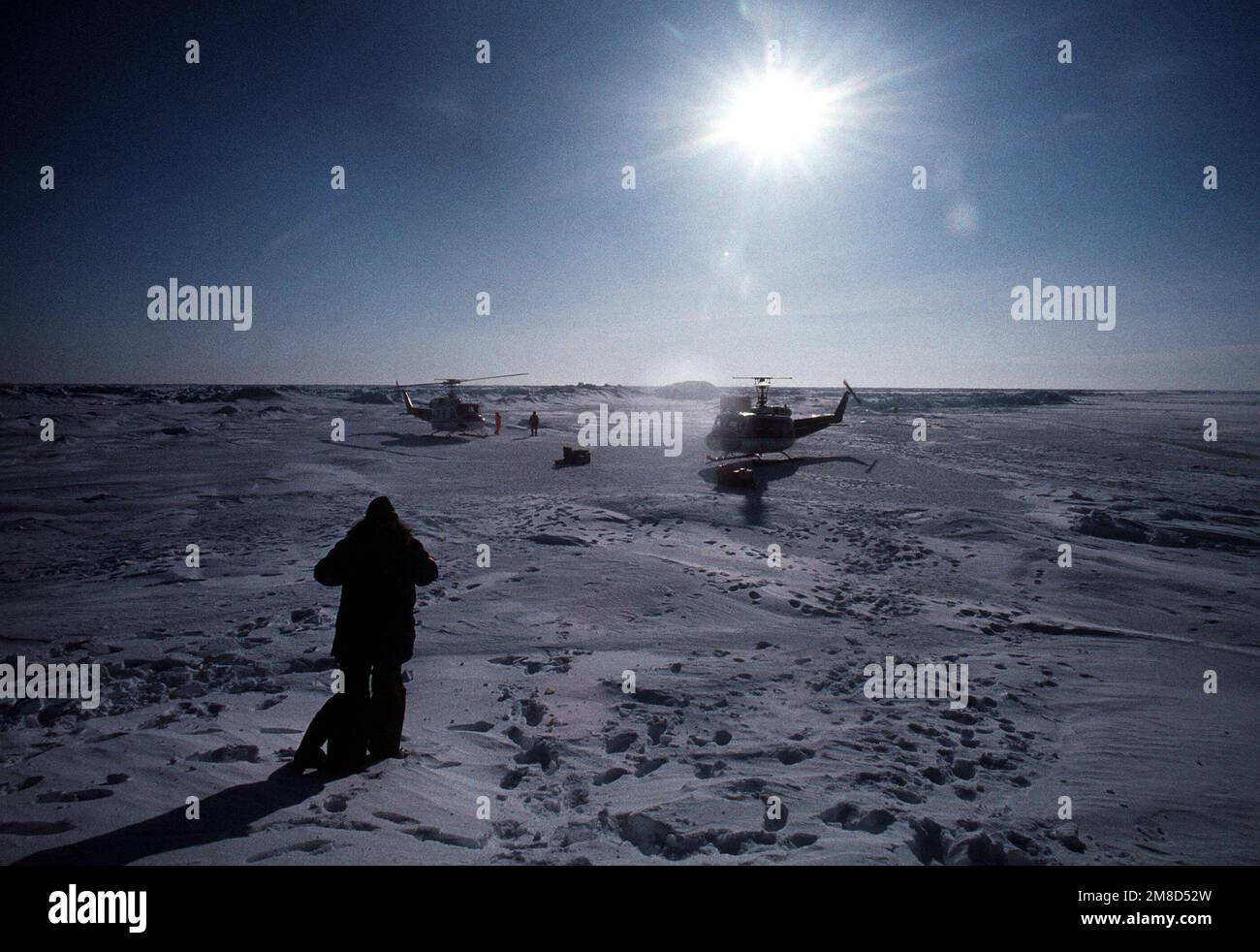 Two UH-1 Iroquois helicopters (UH-1N, left) bring supplies for a team ...