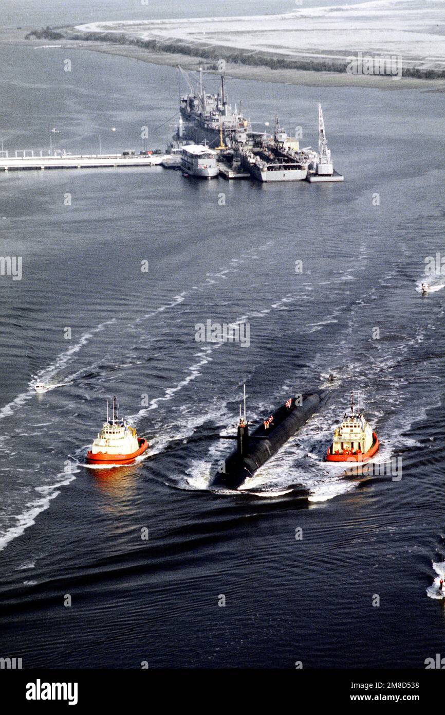Commercial tugs escort the nuclear-powered strategic missile submarine ...