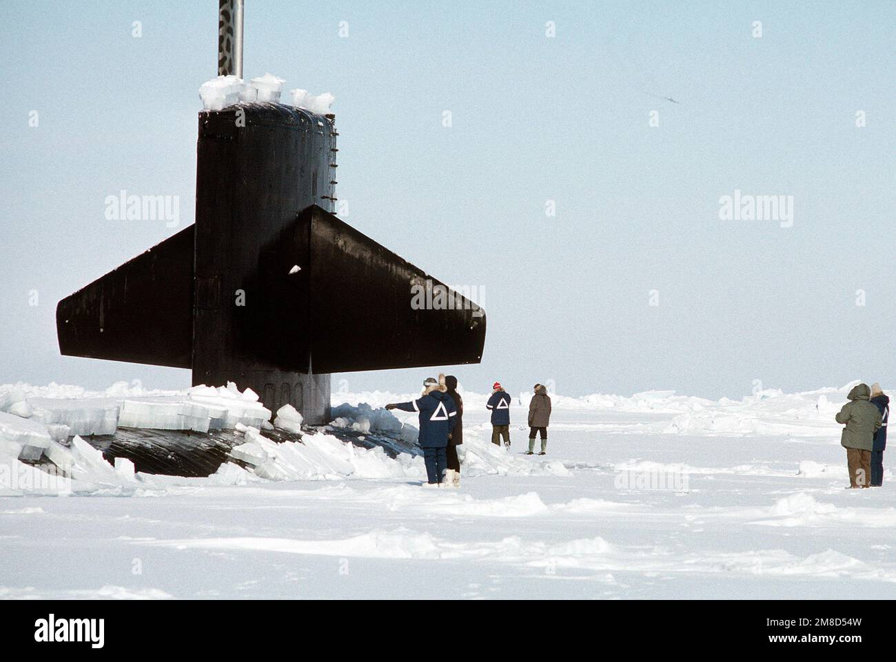 Naval personnel stand by the sail structure of the nuclear-powered ...