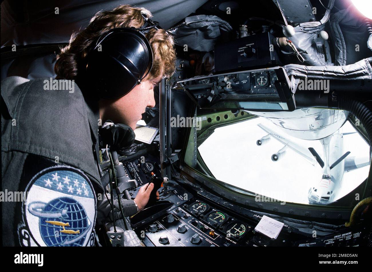 AIRMAN Hassie Snyder operates the controls and watches from her boom ...