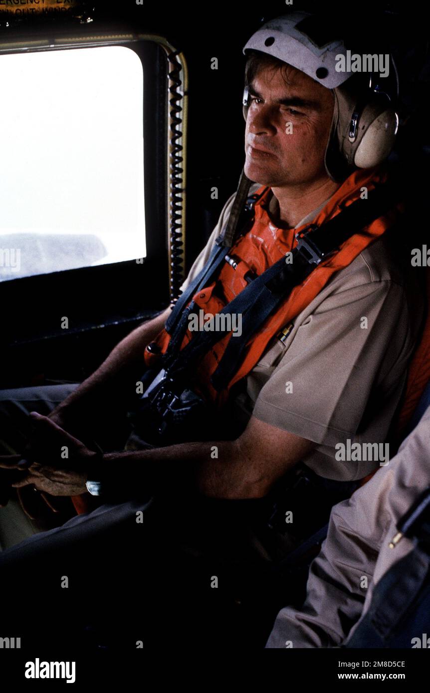 An officer watches from a helicopter as the nuclear-powered strategic ...