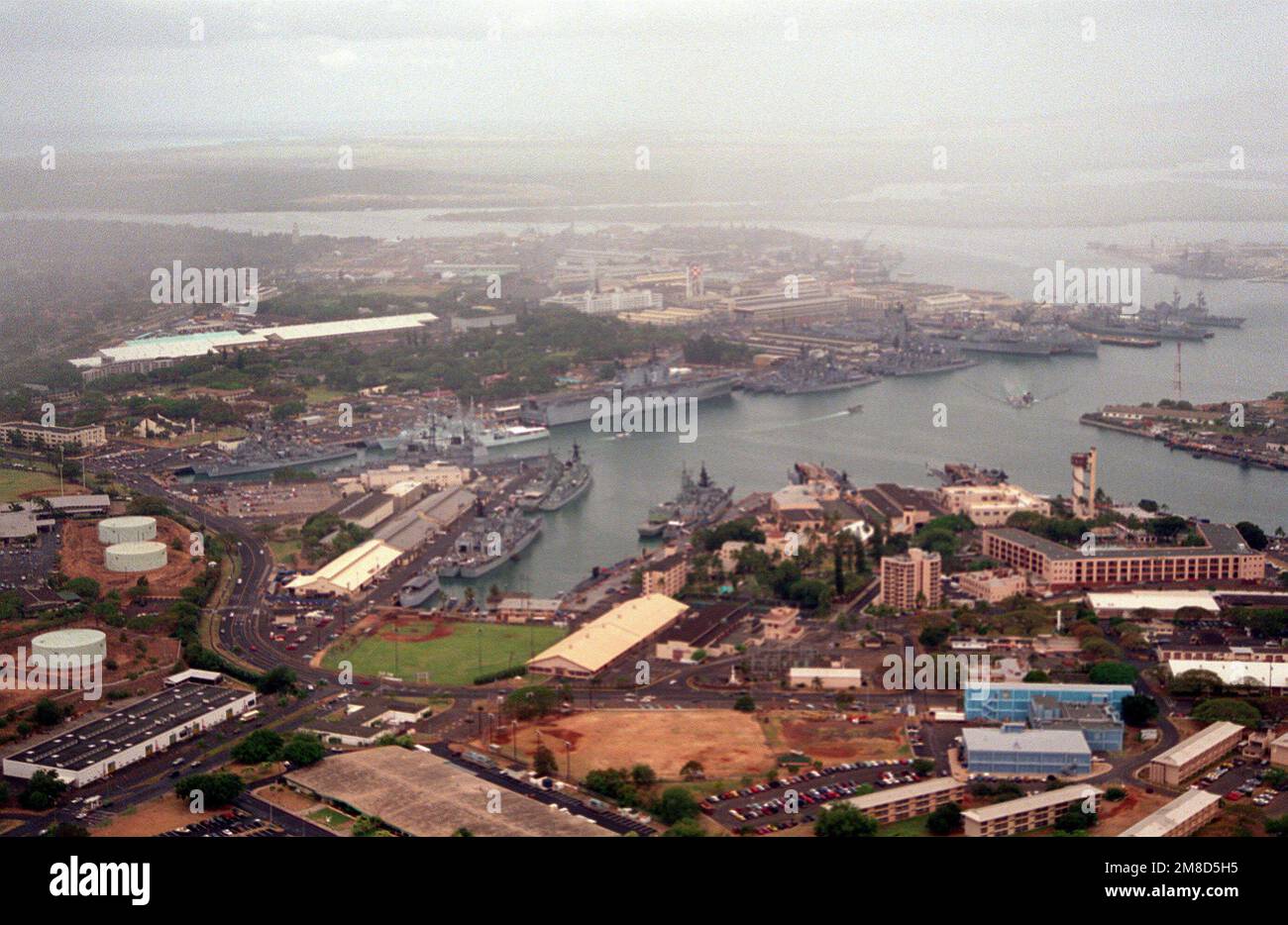 An aerial view of U.S. Navy vessels in port. Base: Naval Station, Pearl ...
