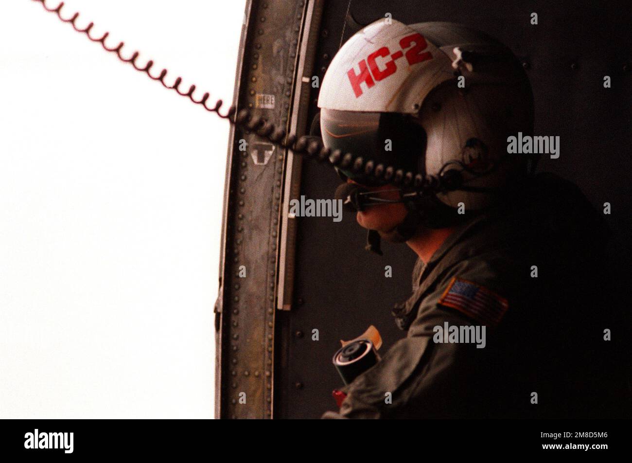 A member of Helicopter Combat Support Squadron 2 (HC-2) looks out the ...