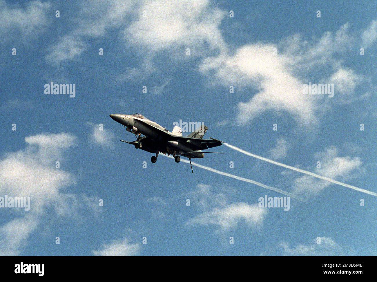 A Strike Fighter Squadron 25 (VFA-25) F/A-18C Hornet aircraft comes in ...