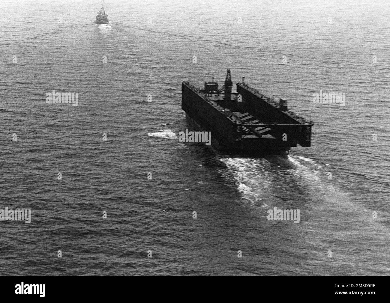 A view of an unidentified floating dry dock under tow. Country ...