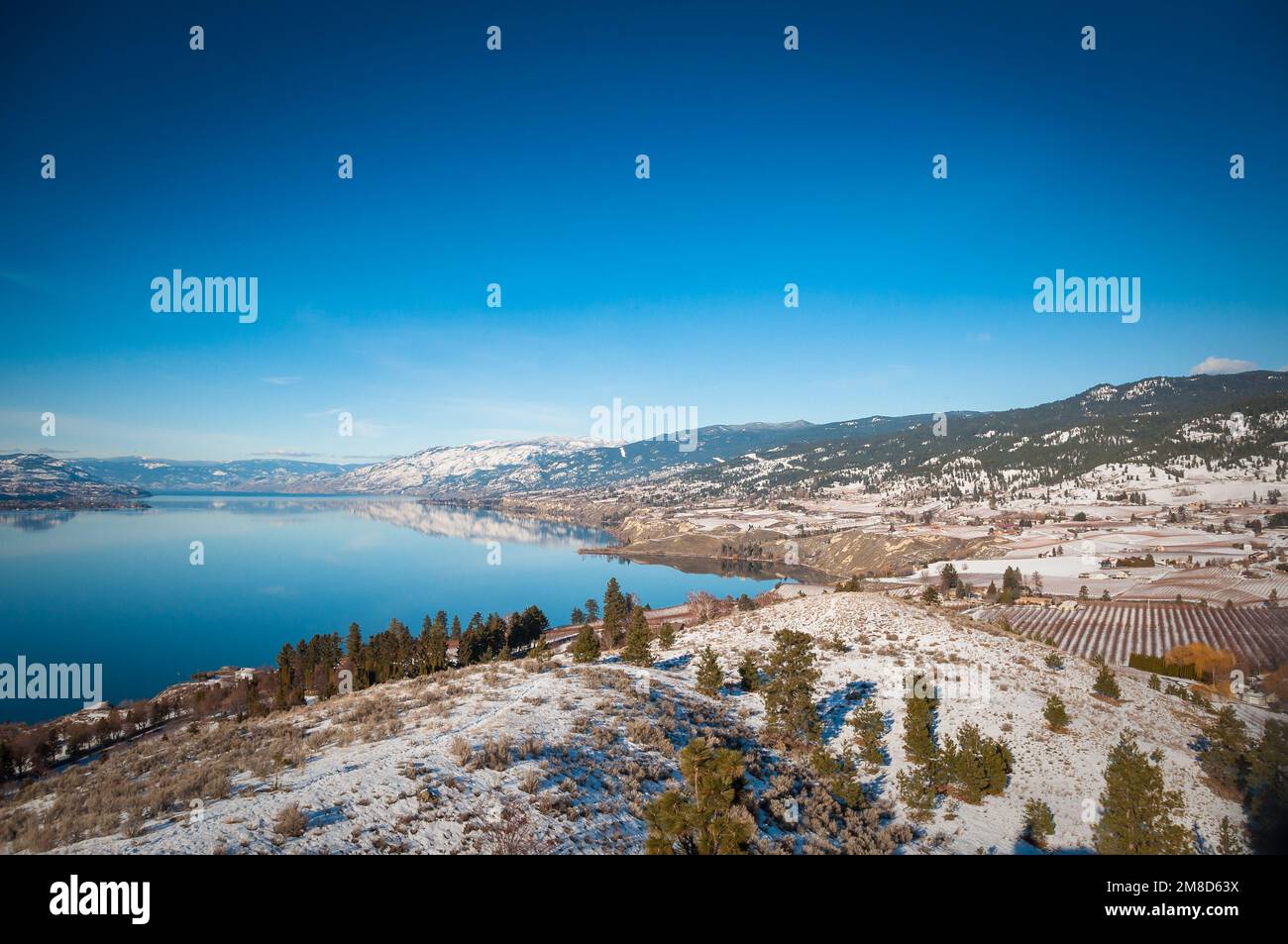 A high-angle view of a Okanagan lake and Munson mountain during the ...