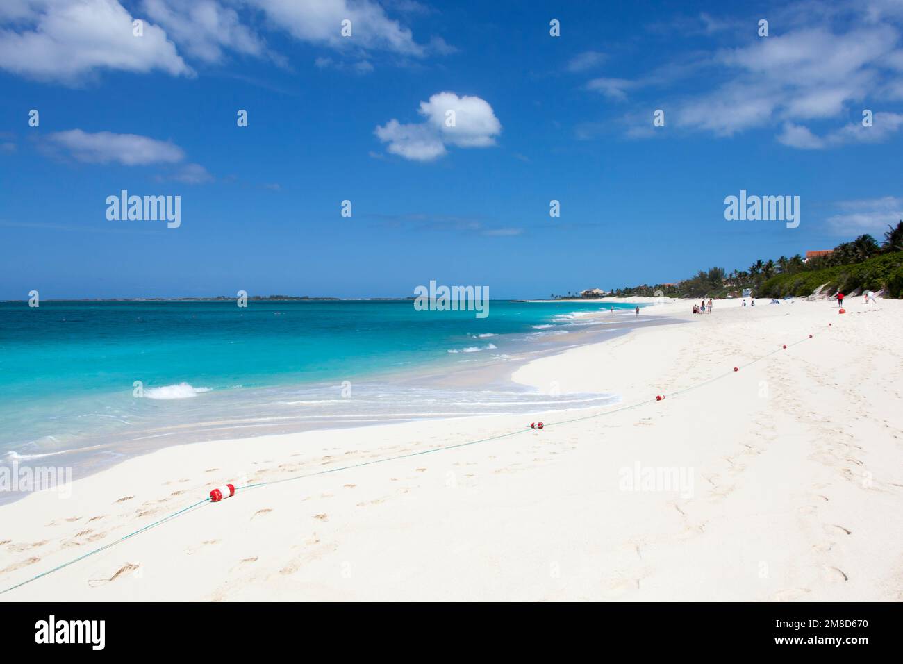 The scenic view of the wide sandy beach and a colorful sea on Paradise ...