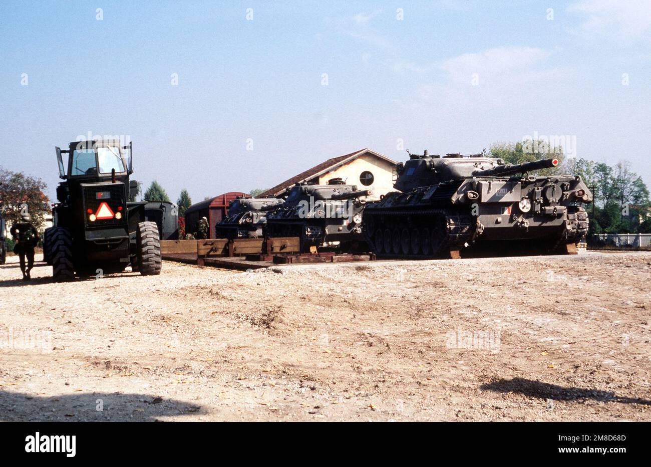 Three Italian army Leopard 1 main battle tanks sit in a staging area at ...