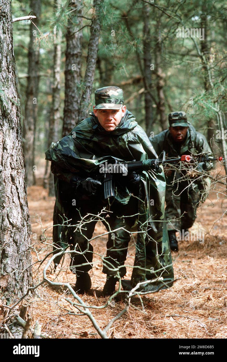 CPT Phil Schwartz leads a group Air Force security police carrying M-16 ...
