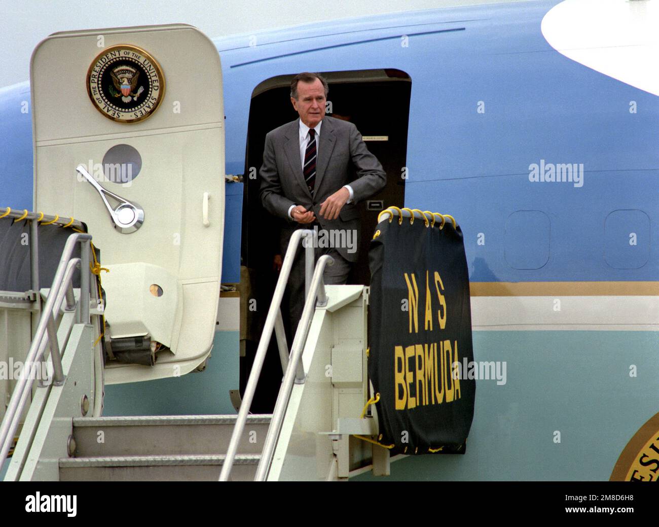 President George Bush is seen disembarking from Air Force One upon his ...