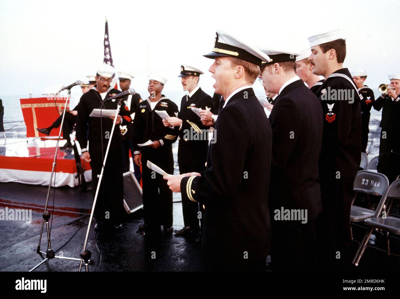 Choir members sing during a sunrise Easter service for the crew of the ...