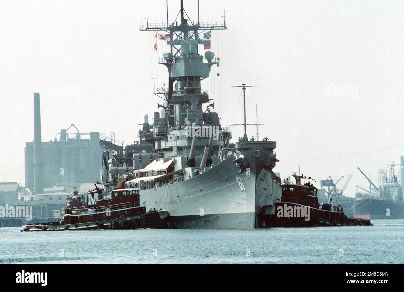 Tugs assist the battleship USS IOWA (BB 61) along the Elizabeth River ...