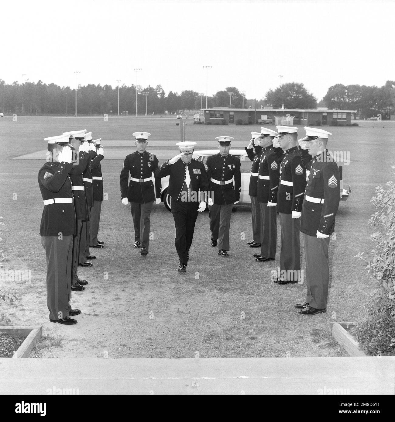 An honor guard salutes as General Alfred M. Gray, Commandant of the ...