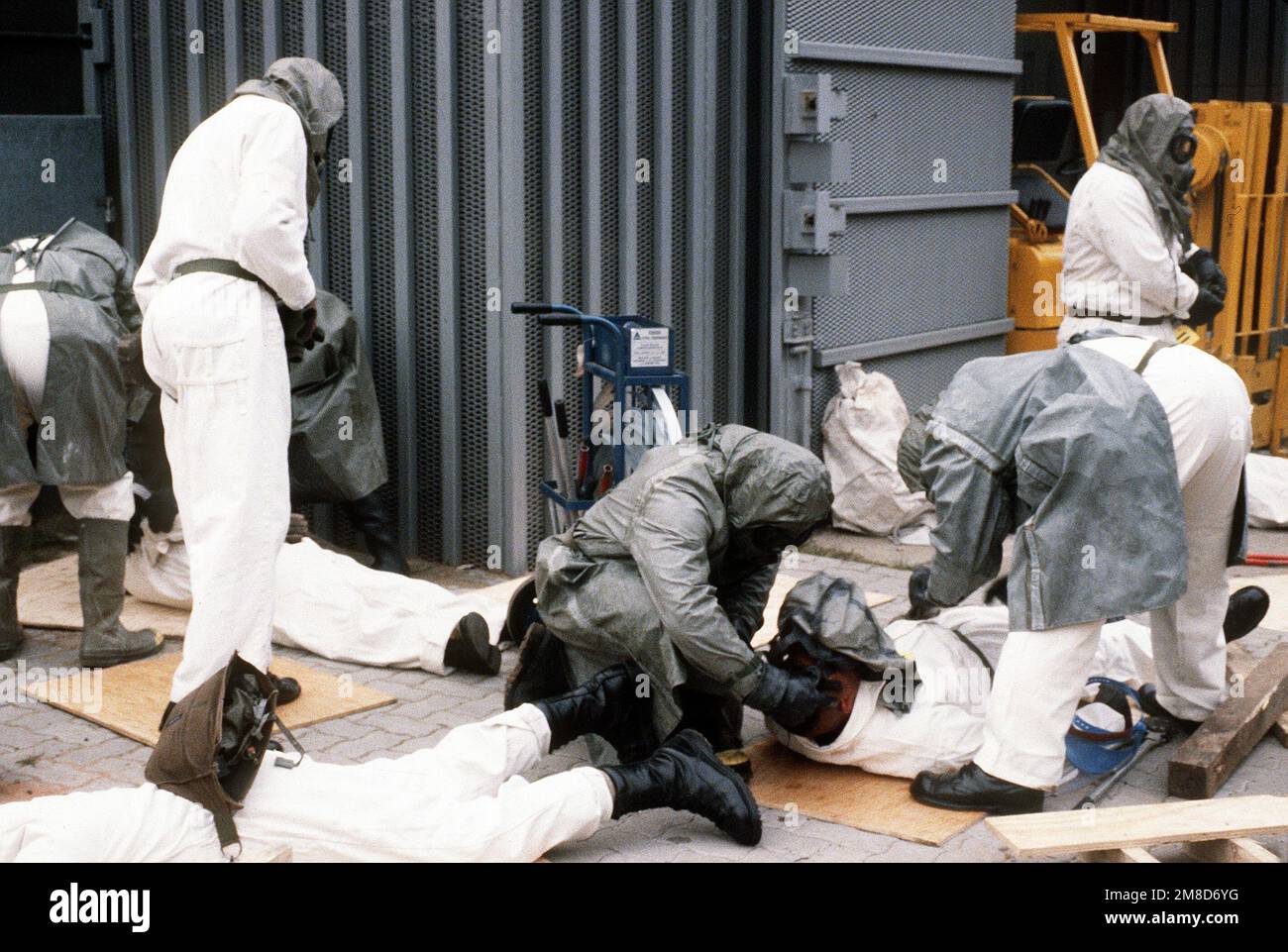 Medical personnel wearing nuclear-biological- chemical (NBC protective ...