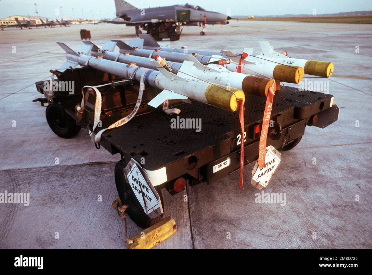 A rack of AIM-9 Sidewinder missiles waits to be loaded on a F-4G ...