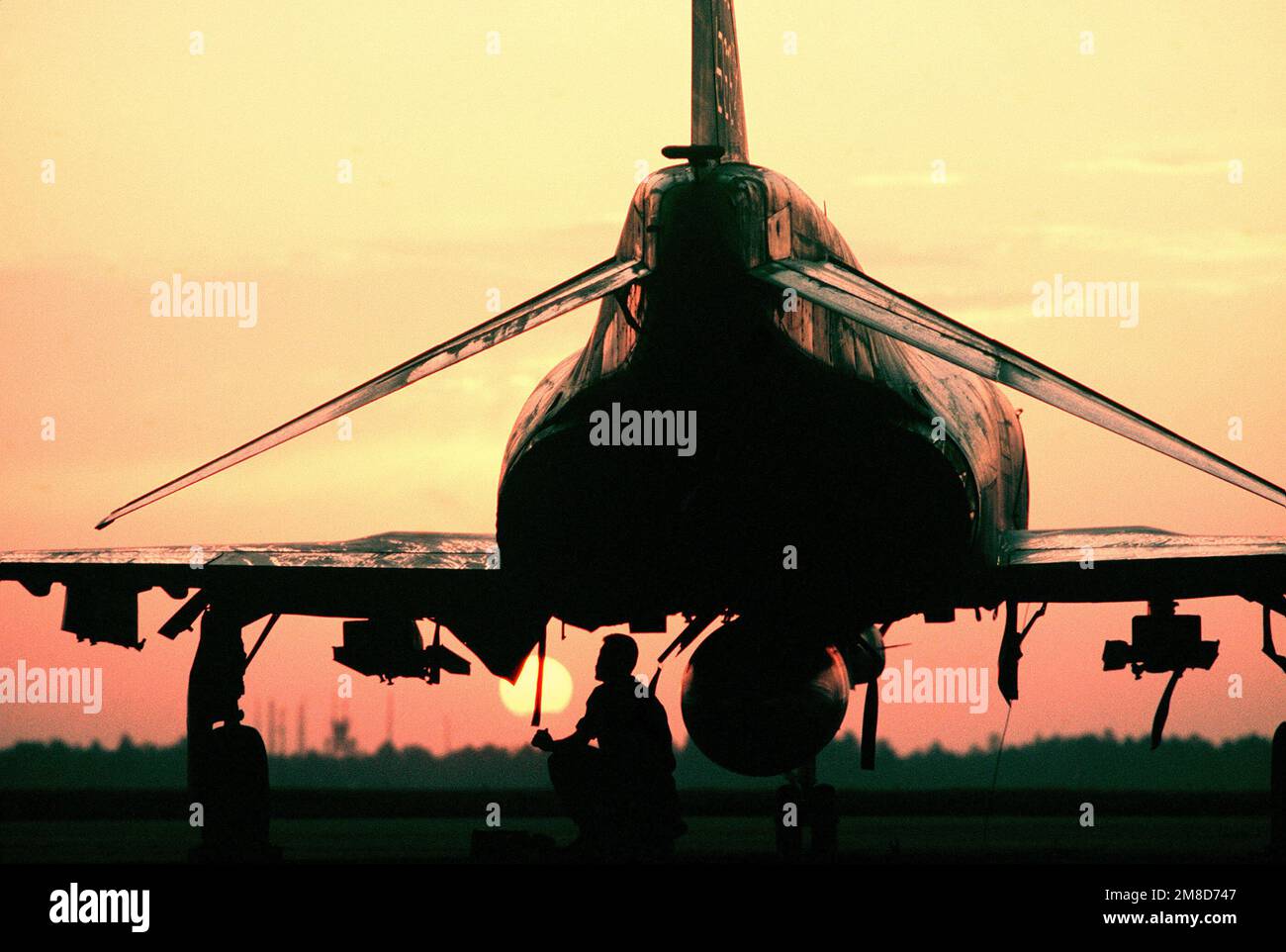A technician working underneath a 37th Tactical Fighter Wing F-4 ...