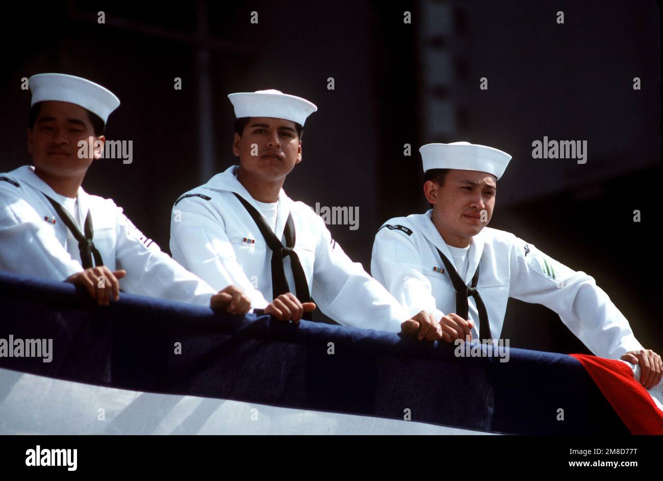 Crew members watch the activities during the decommissioning ceremony ...