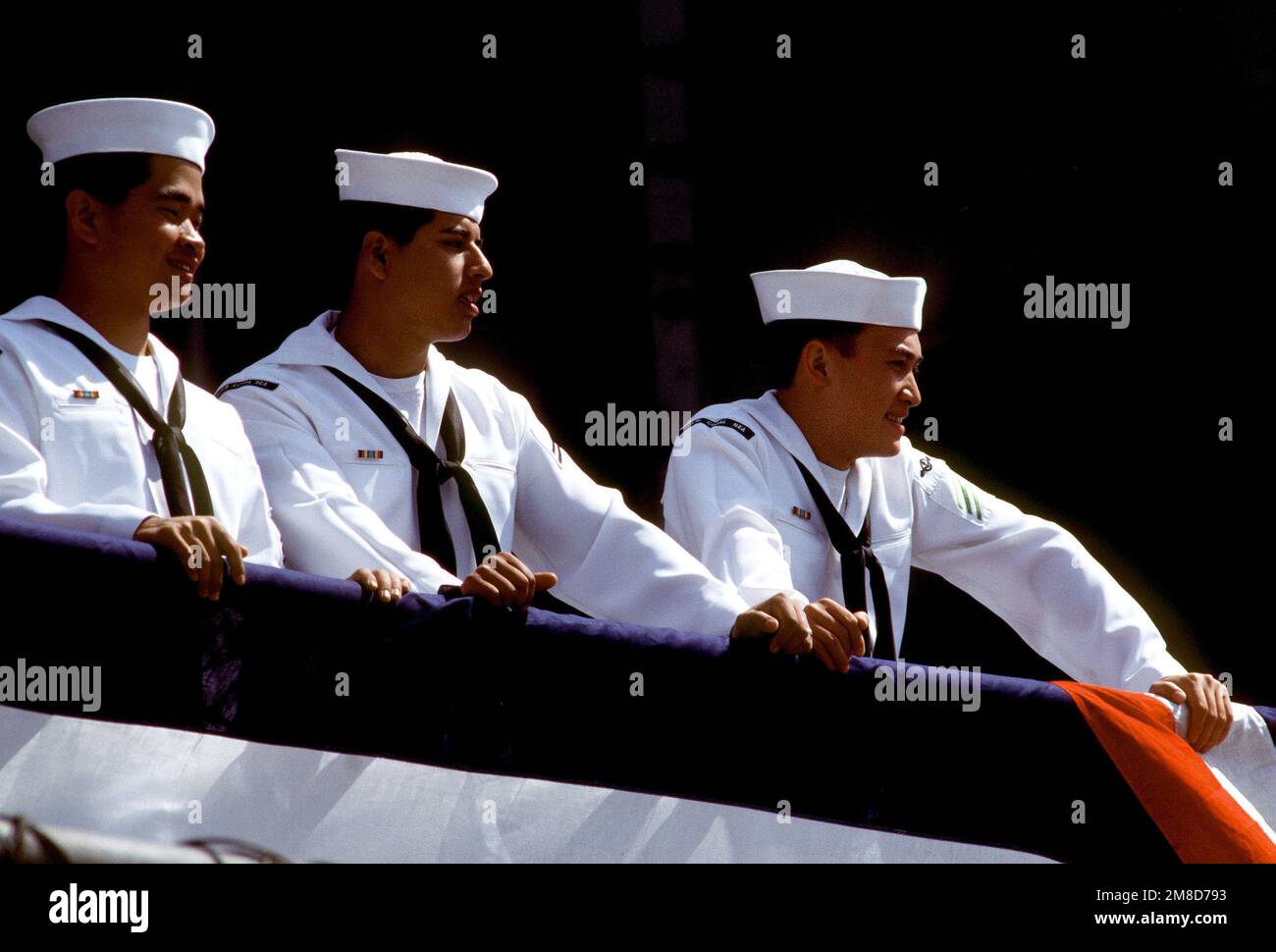 Crew members watch the activities during the decommissioning ceremony ...