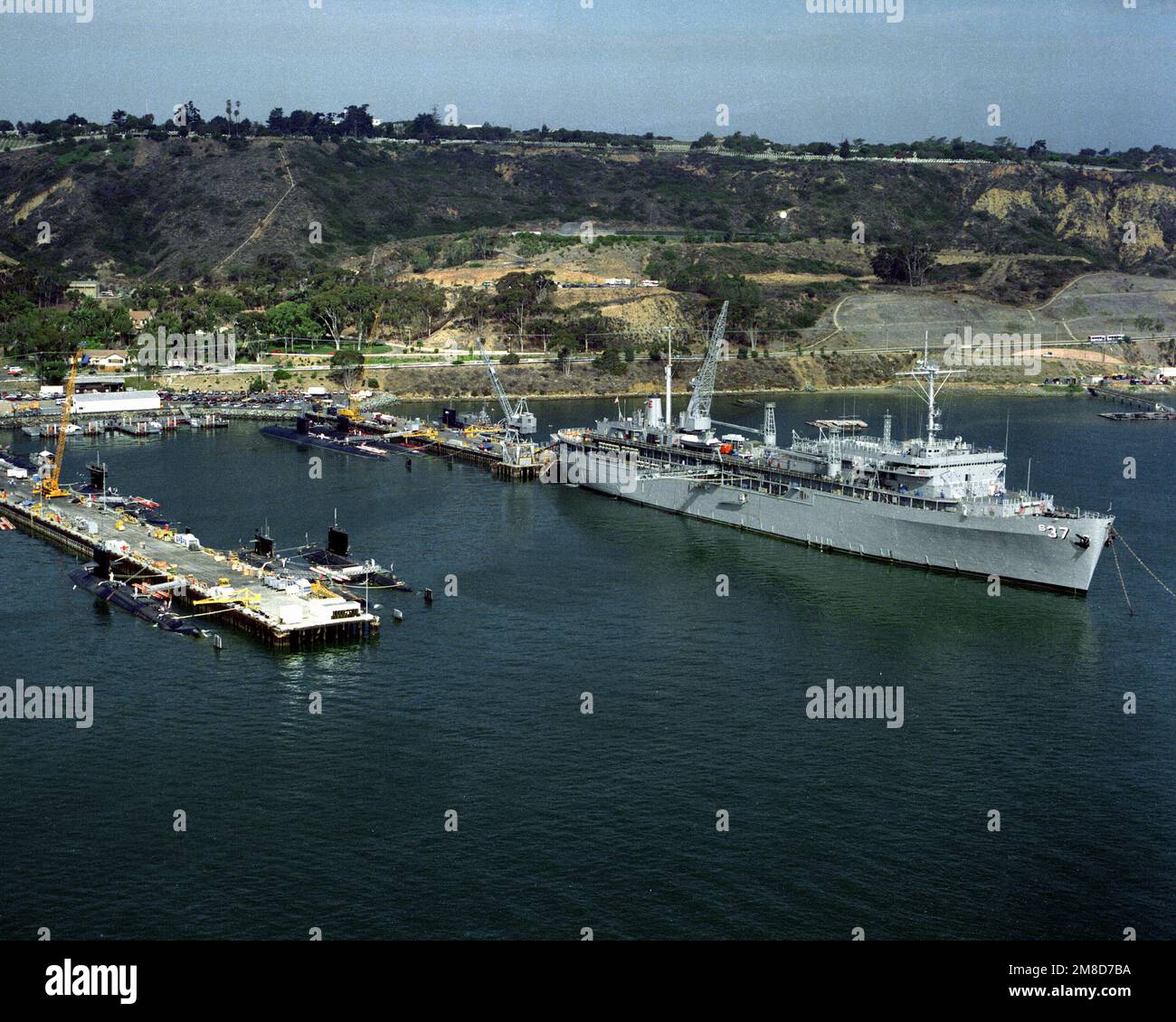 A starboard bow view of the submarine tender USS DIXON (AS-37) moored ...