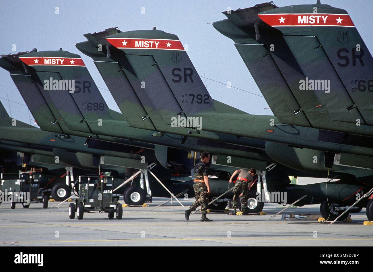 Ground crewmen inspect one of several OV-10A Bronco aircraft from the ...