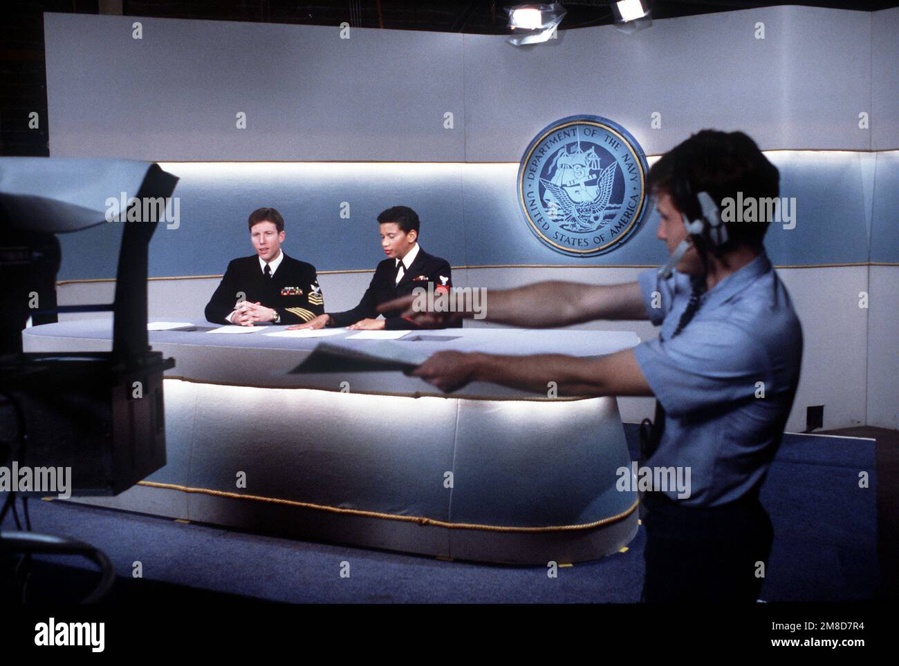 Photographer's Mate 3rd Class James McConnell directs the filming of ...