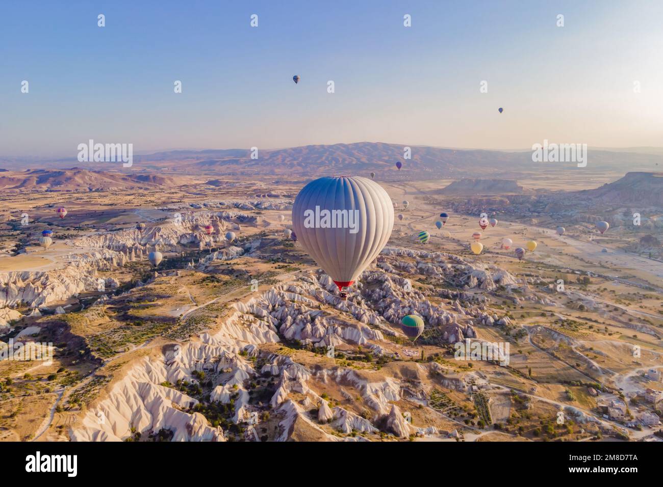Colorful hot air balloons flying over at fairy chimneys valley in ...