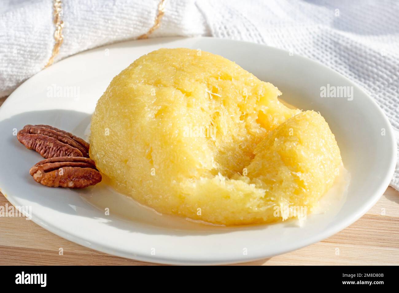 Sweet yellow Turkish dessert cheese halva Hosmerim on the white plate ...