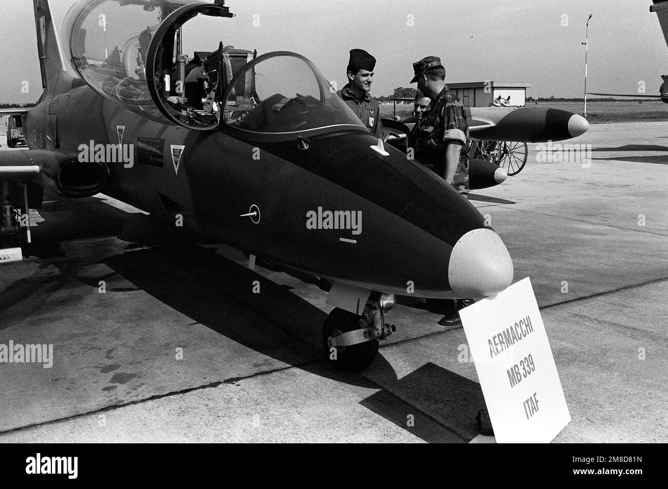 An Italian air force pilot talks to some visitors as he stands beside ...