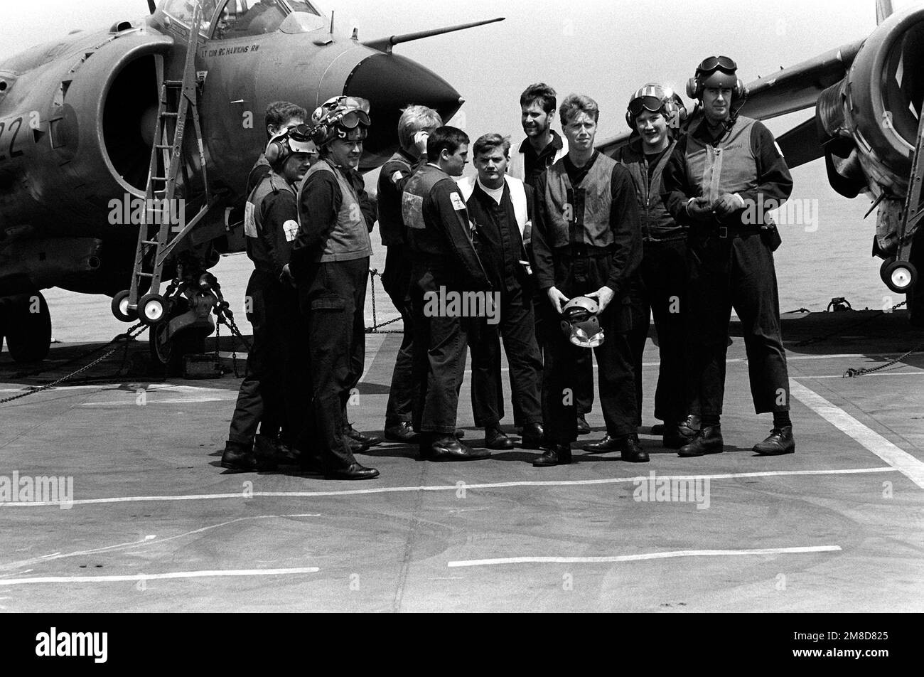 Squadron personnel gather near two of their FRS. Mark 1 Sea Harrier ...
