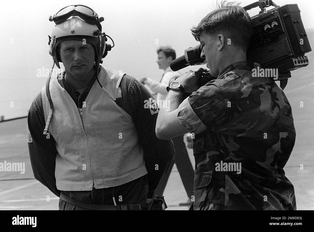 A United States (US) Navy video cameraman gets a close-up of the patch ...