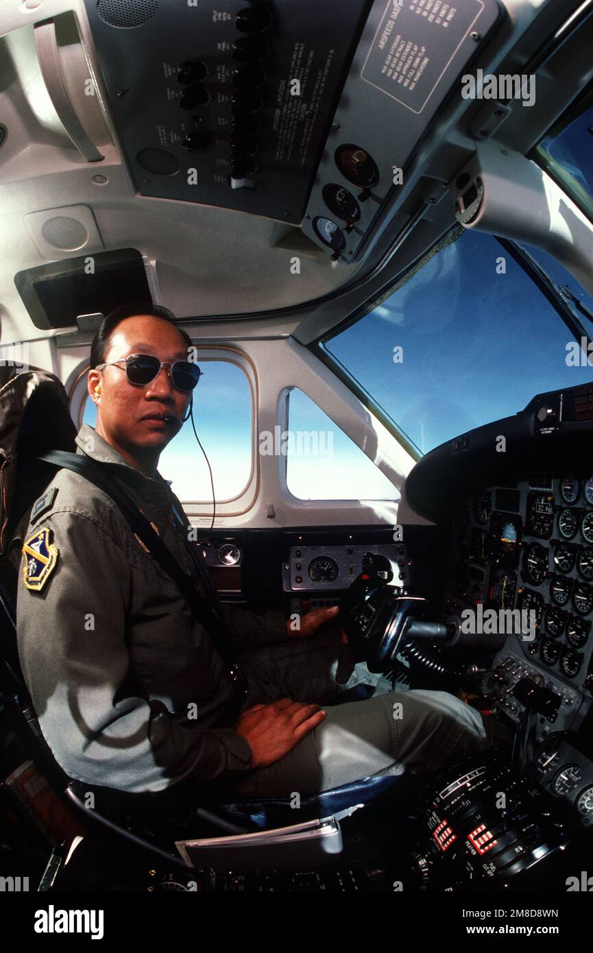 Captain Bill Chu monitors instrument panels in the cockpit of a C-12F ...