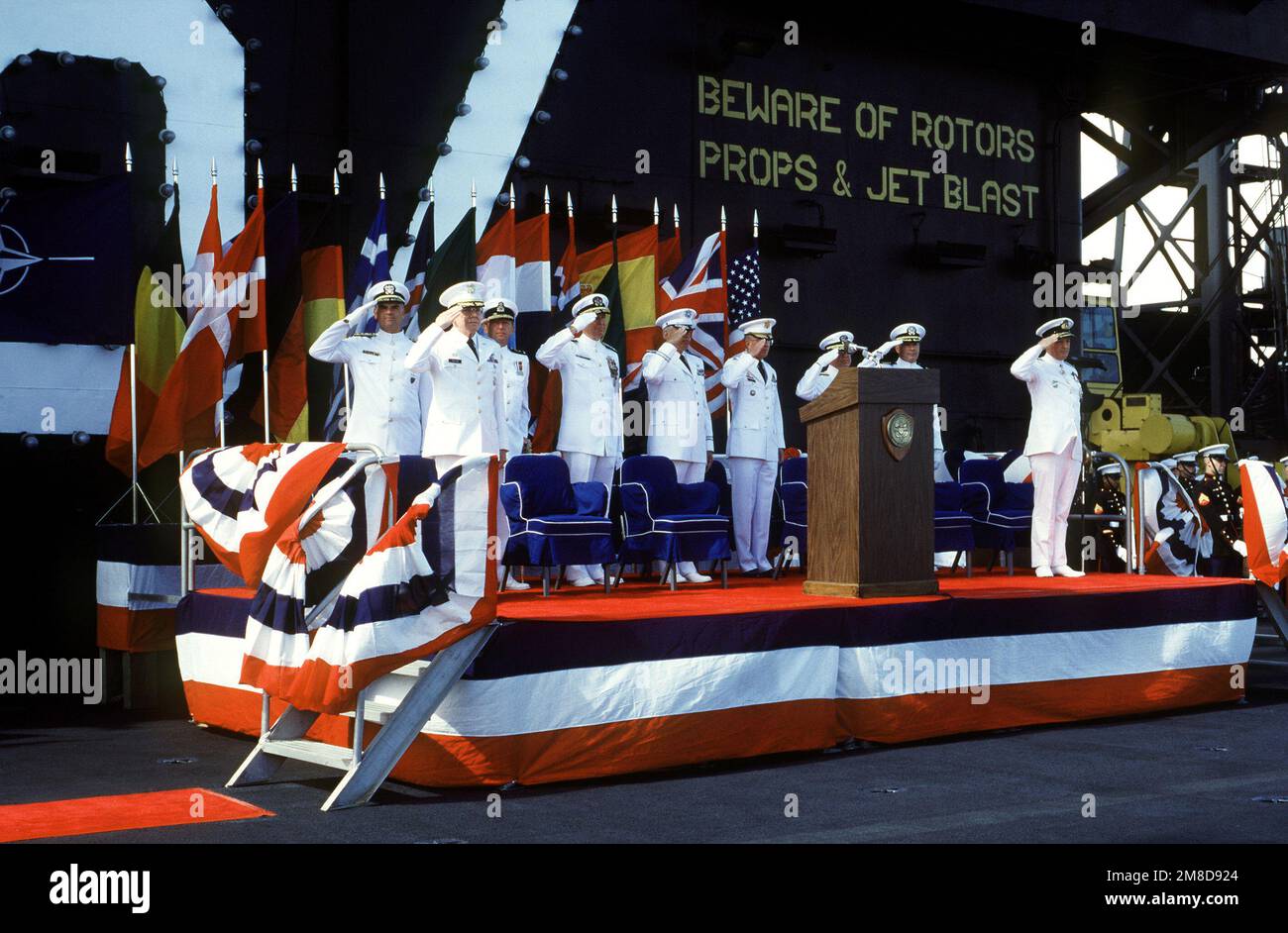 Flag officers salute during the change of command ceremony at which ADM ...