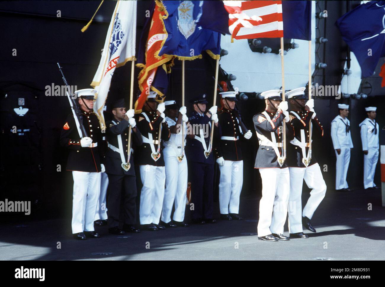A joint services color guard presents the colors during the change of ...