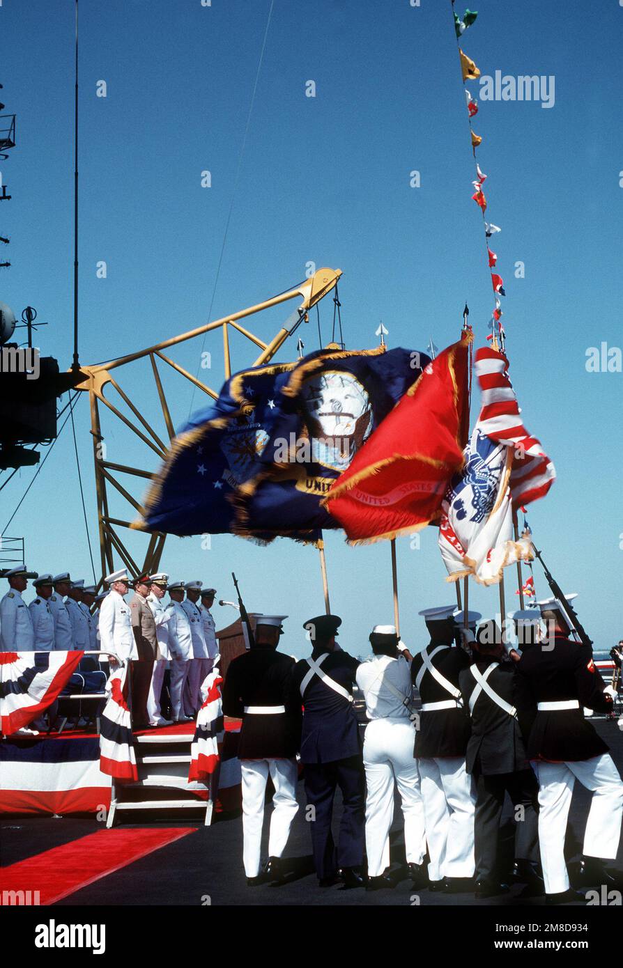 A joint services color guard presents the colors during the change of ...