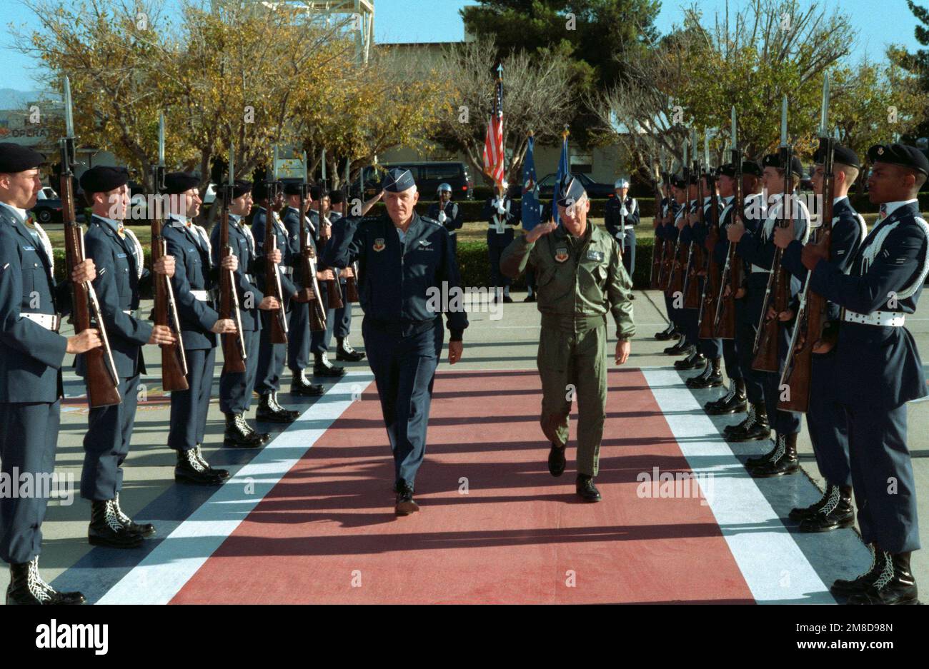 Airmen of the base honor guard hold their M-1 rifles at present arms as ...